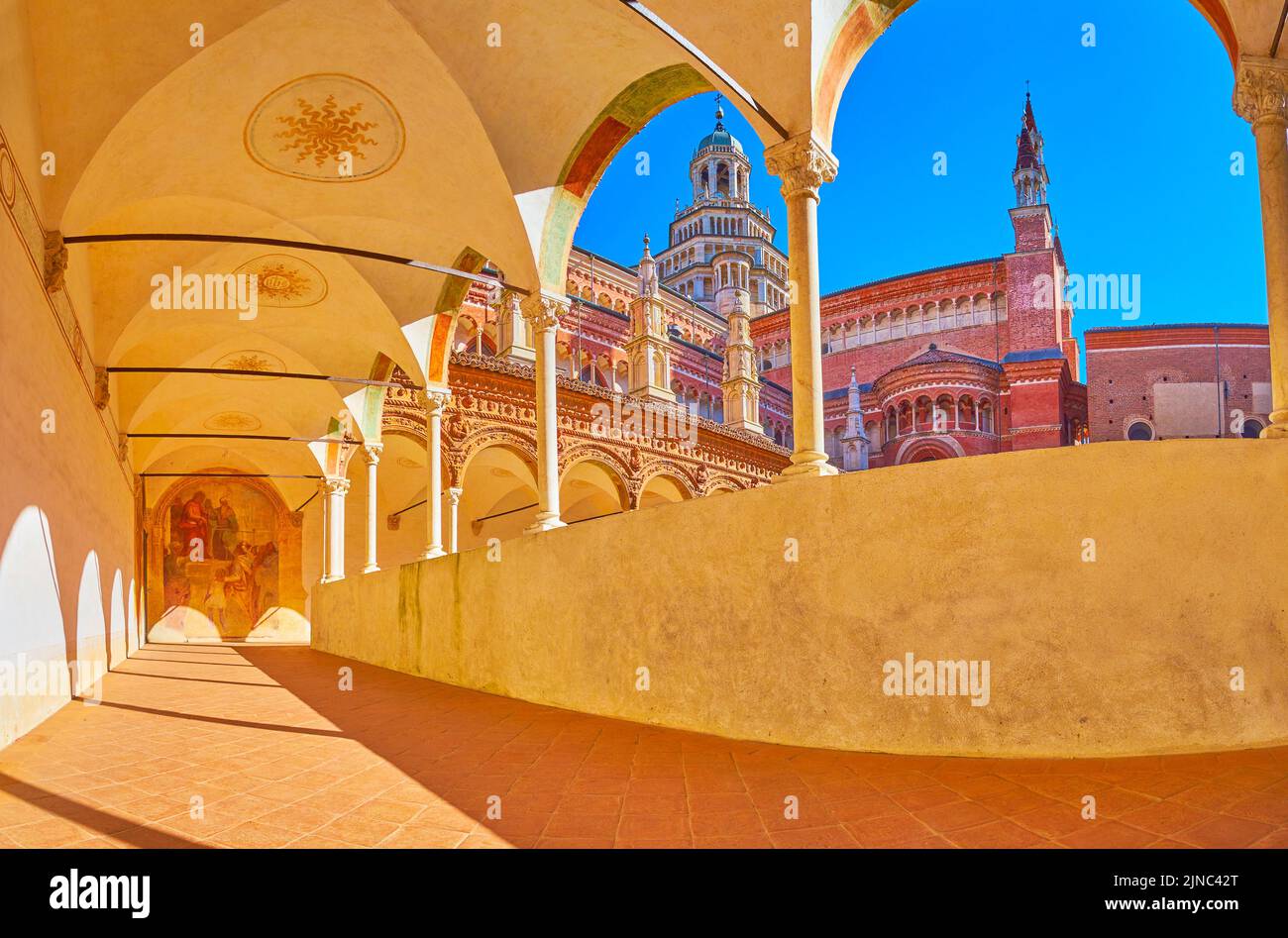 The covered arcaded gallery of the small cloister and the Cathedral of ...