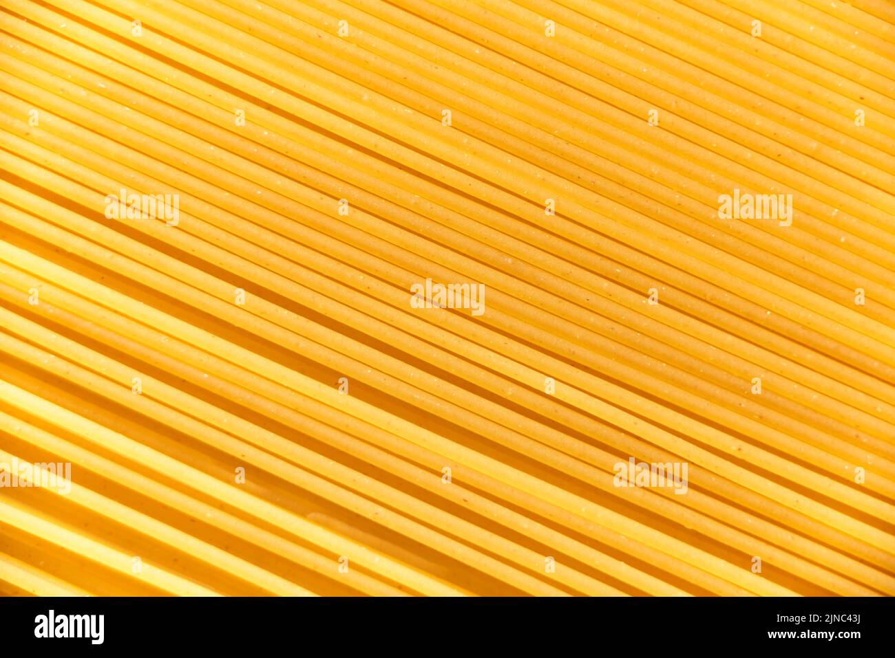 Italian food background, raw spaghetti filling the frame in a textured ...