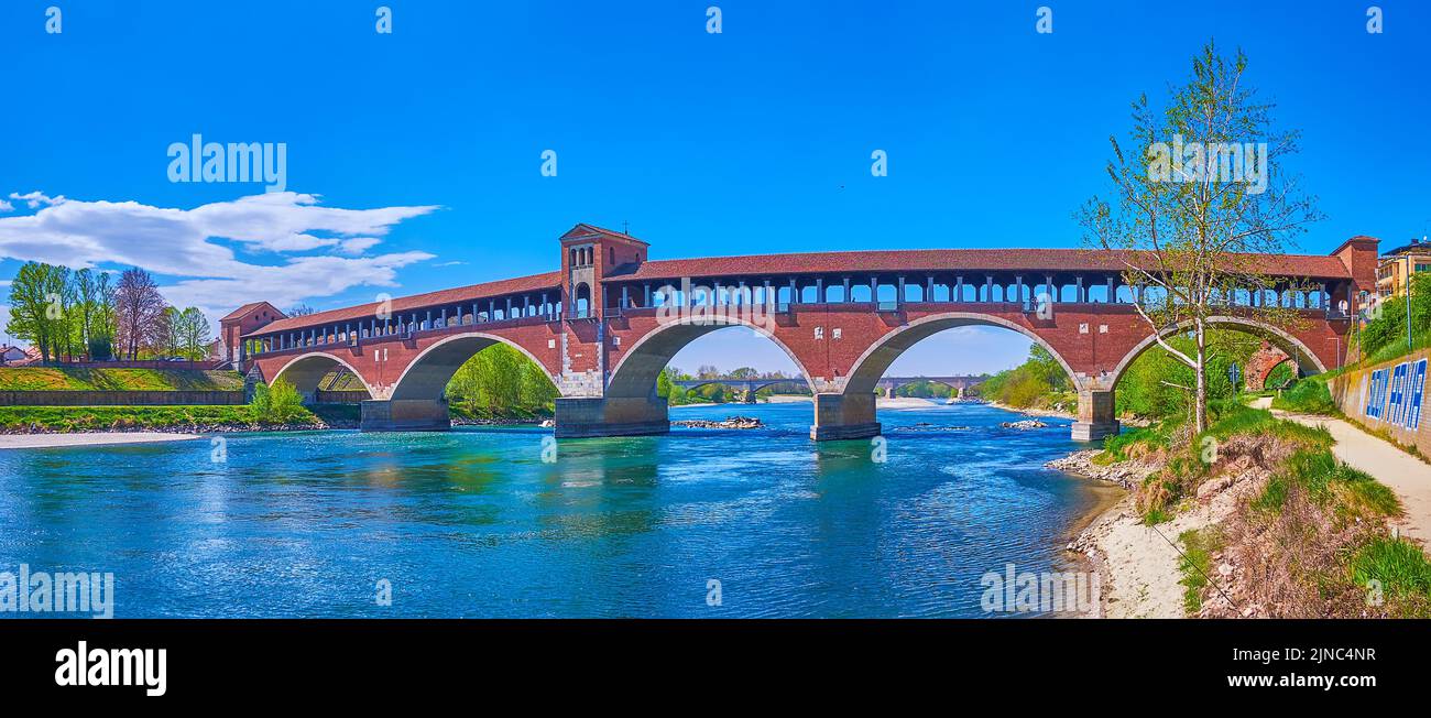 The beautiful covered Ponte Coperto bridge across Ticino river in Pavia ...