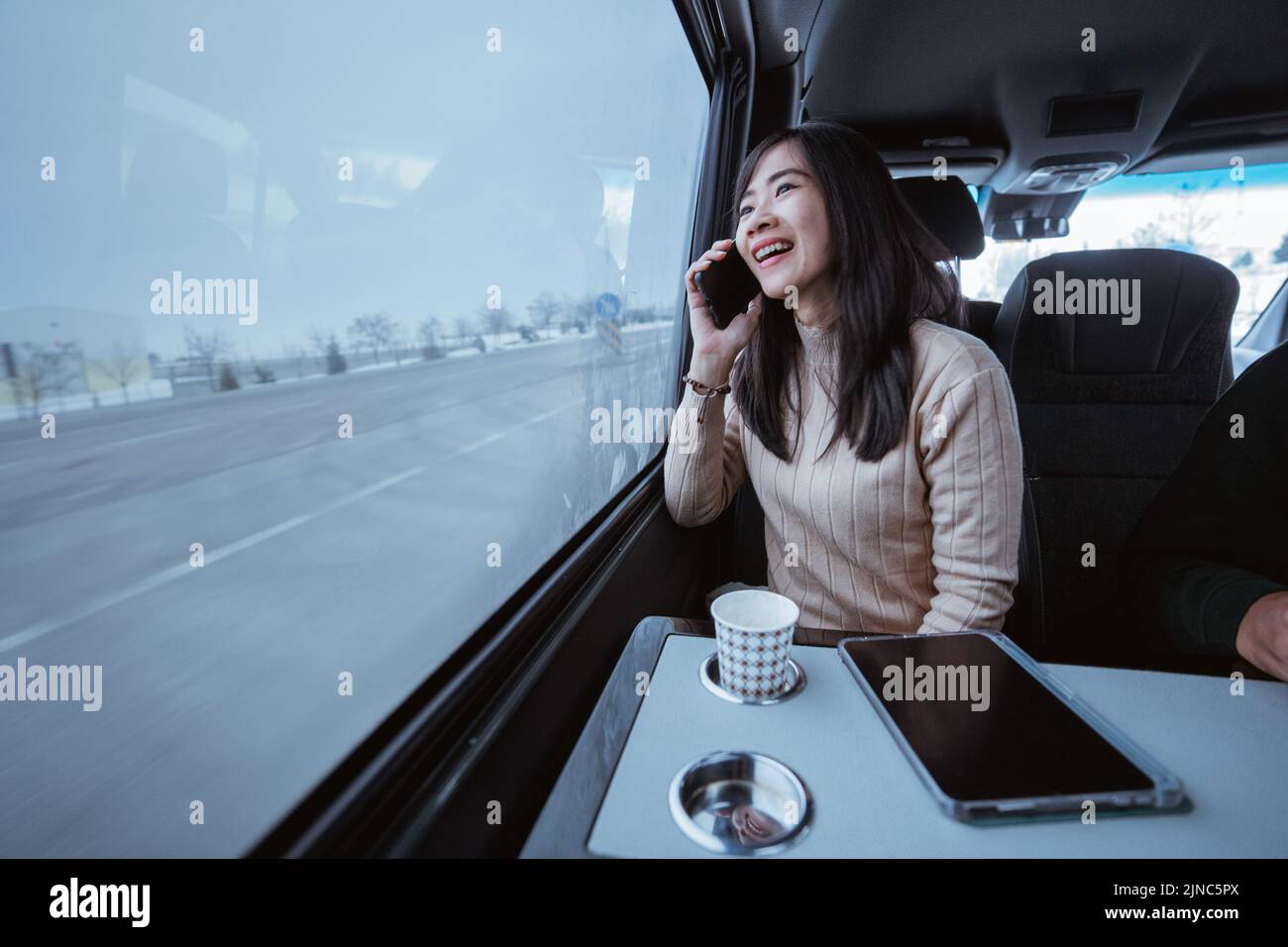woman making a phone call during her trip inside a van Stock Photo - Alamy