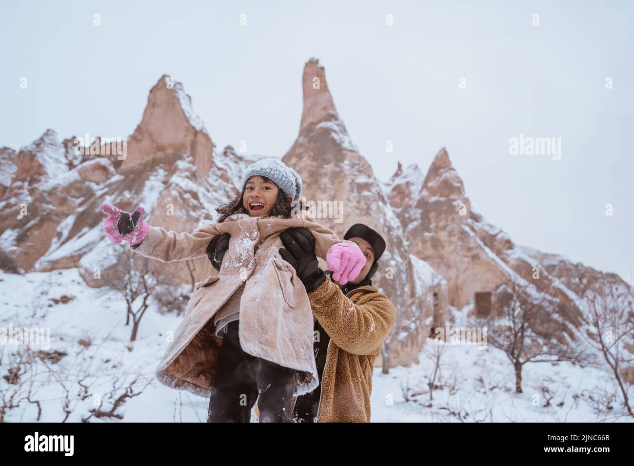 father piggyback ride with daughter while playing outside in snow Stock ...