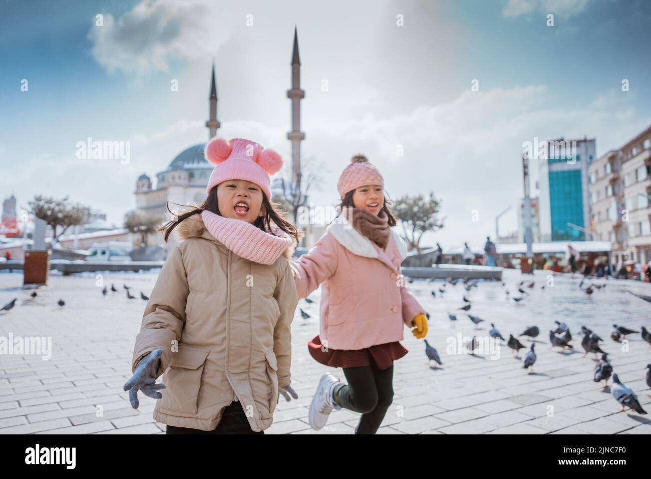 happy kids playing with pigeons in taksim square turkey Stock Photo - Alamy