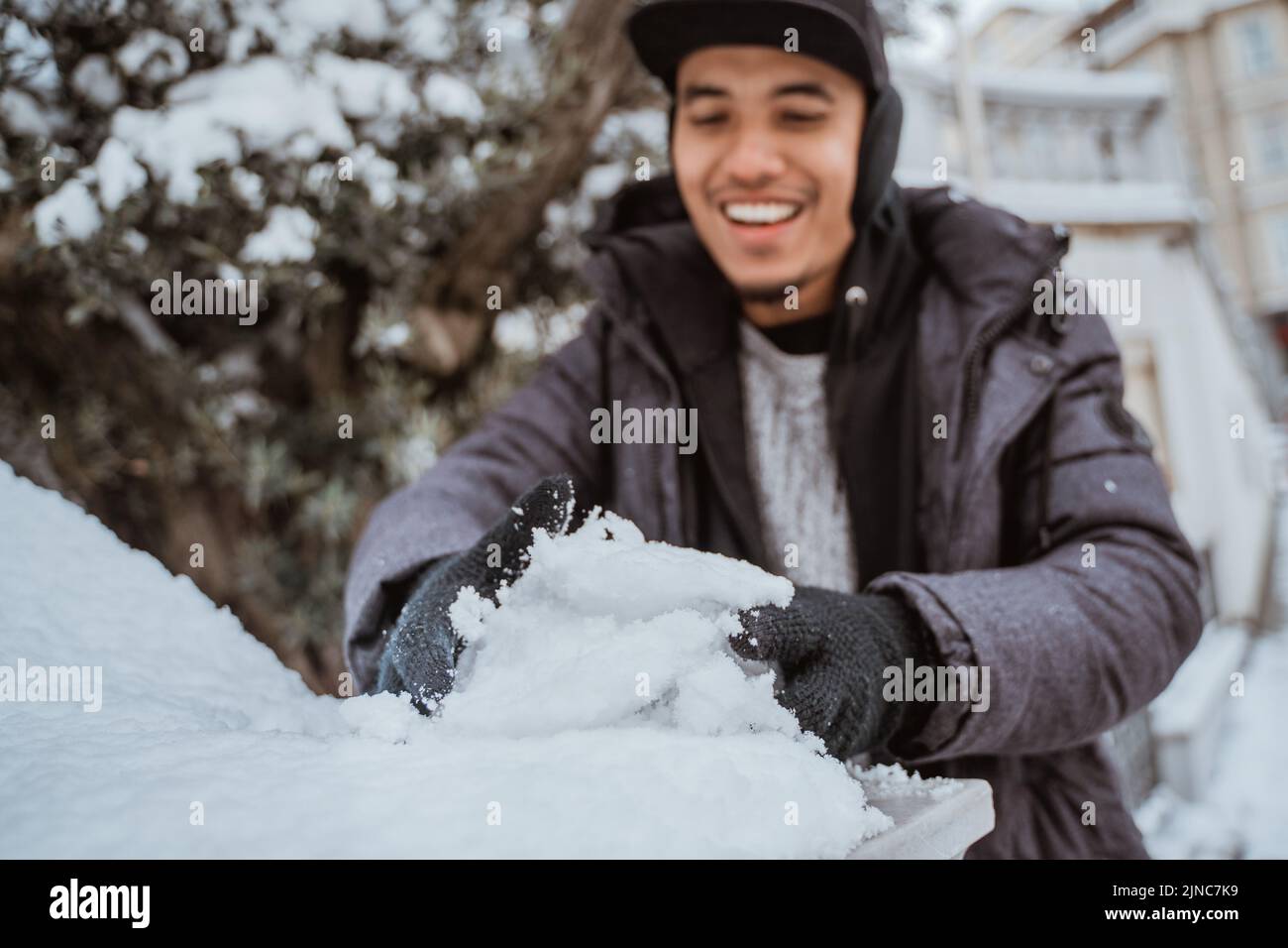 man touching snow for the first time during visiting european country ...