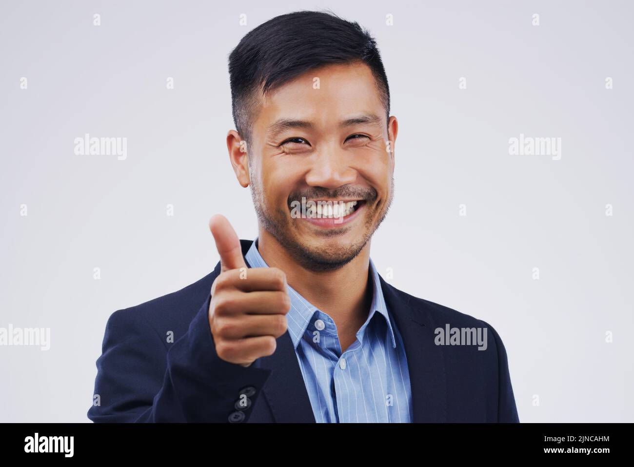 Excellent work. Studio portrait of a handsome young businessman giving ...