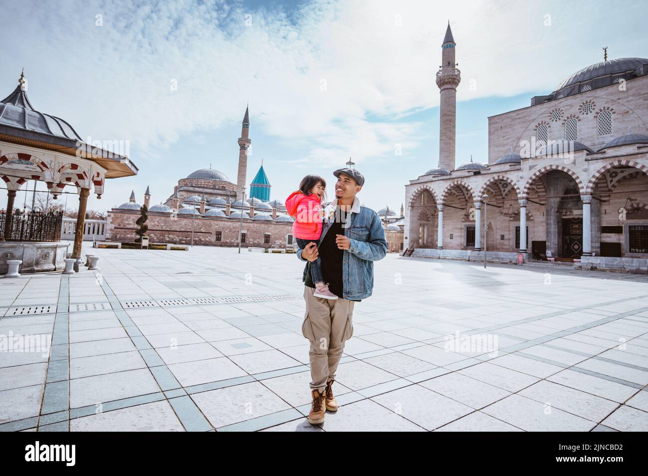 father and his little girl walking around the square in konya turkey ...