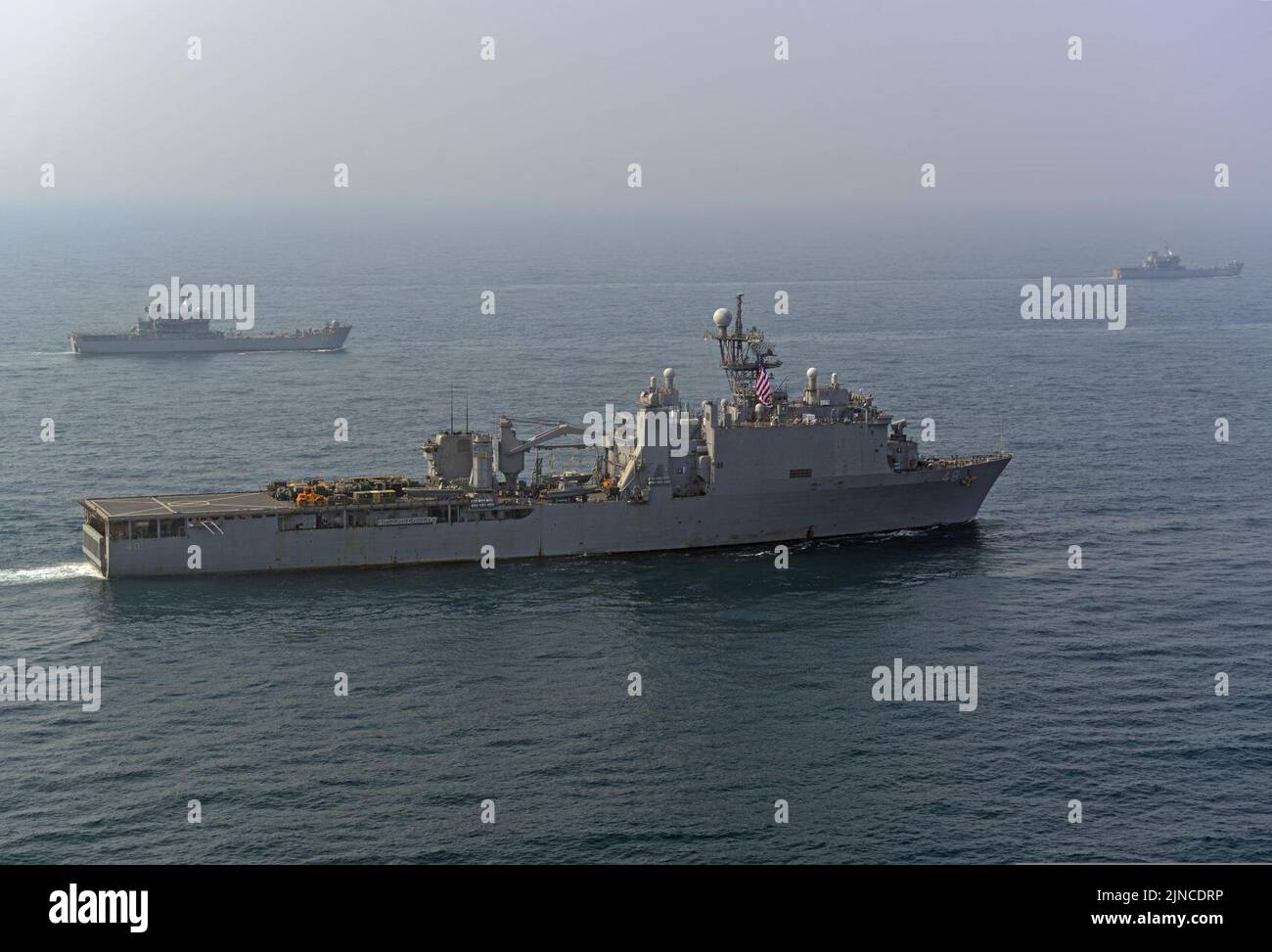 The amphibious transport dock ship USS Denver (LPD 9), front, and other ...