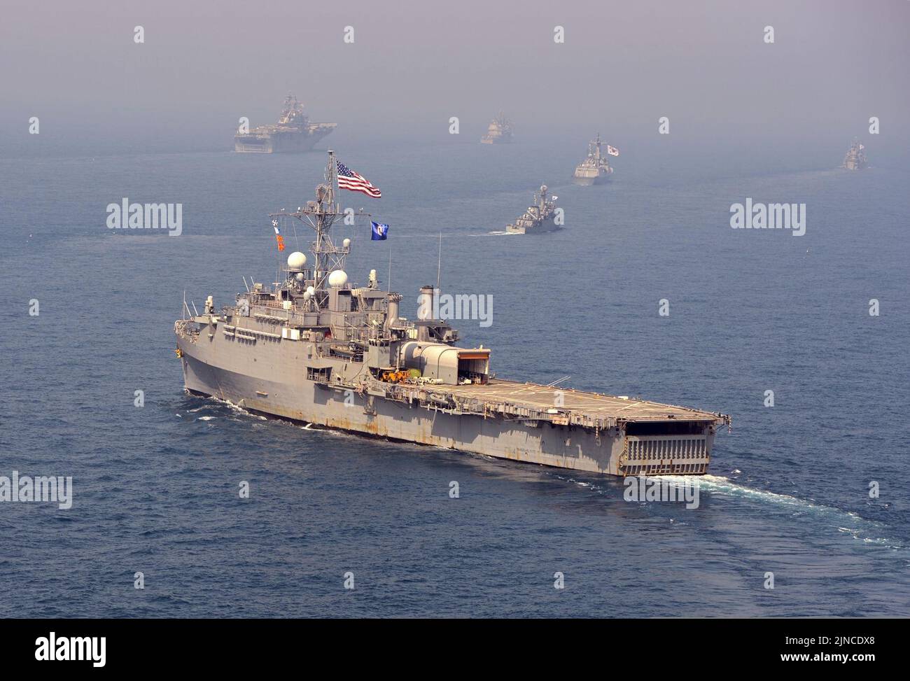 The amphibious transport dock ship USS Denver (LPD 9), front, a part of ...
