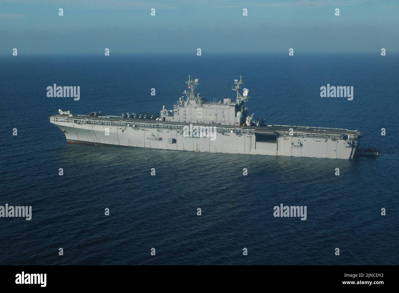 The amphibious assault ship USS Peleliu (LHA 5) stages along the coast ...