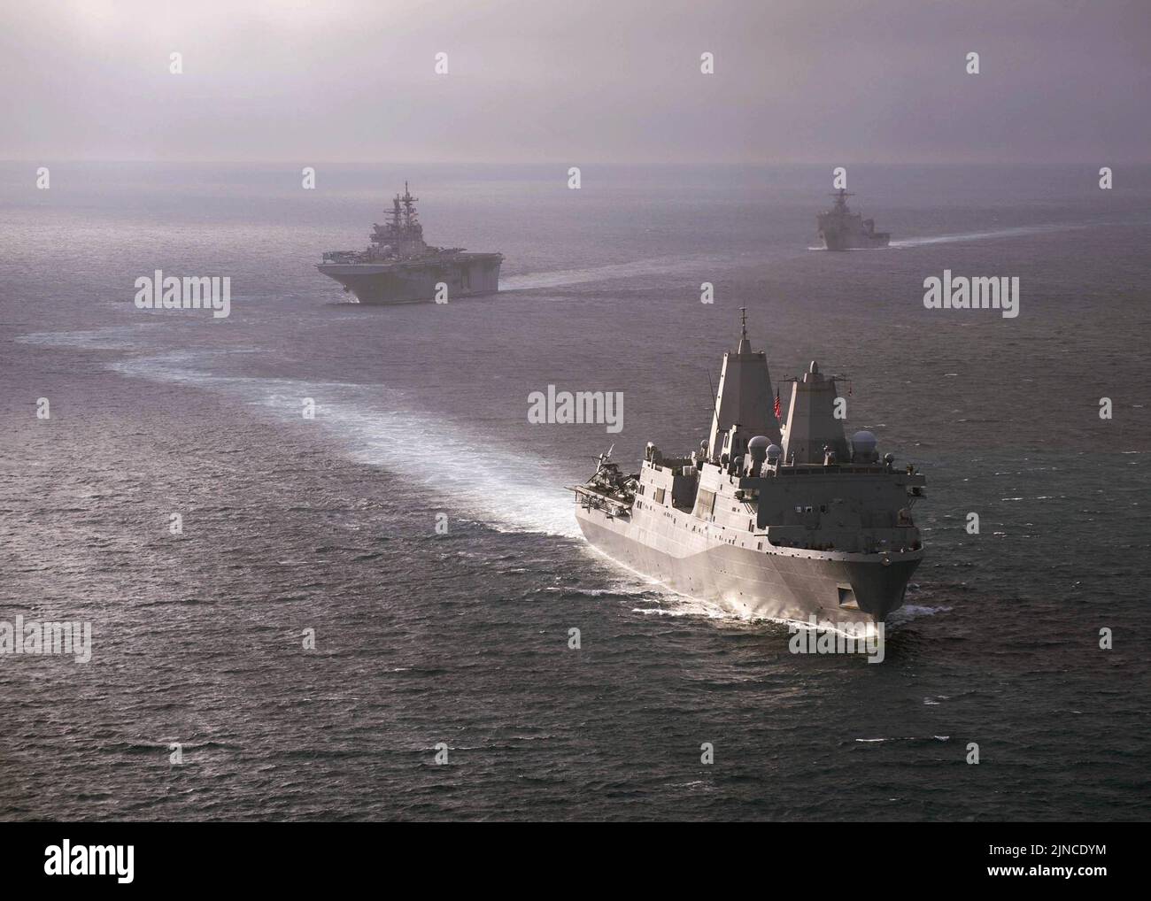 The amphibious transport dock ship USS San Diego (LPD 22) leads the ...