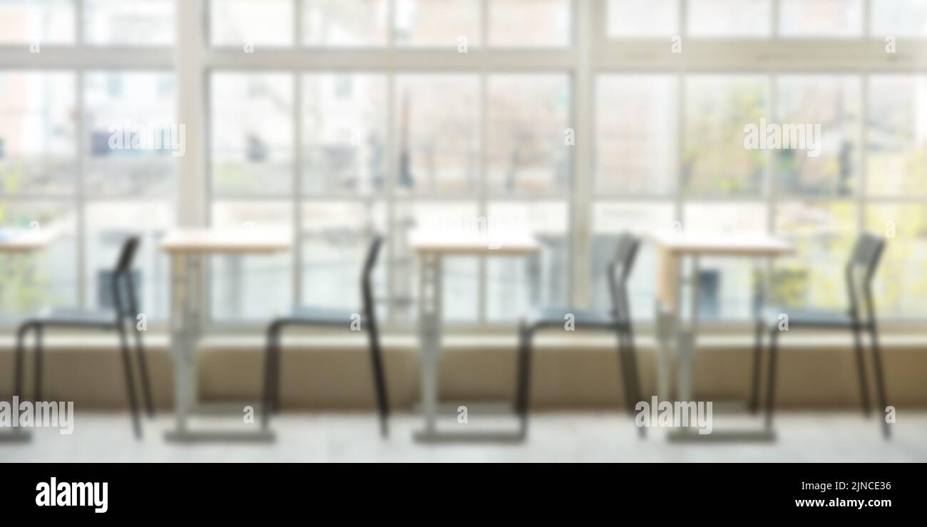 Interior of big empty classroom, blurred view Stock Photo - Alamy