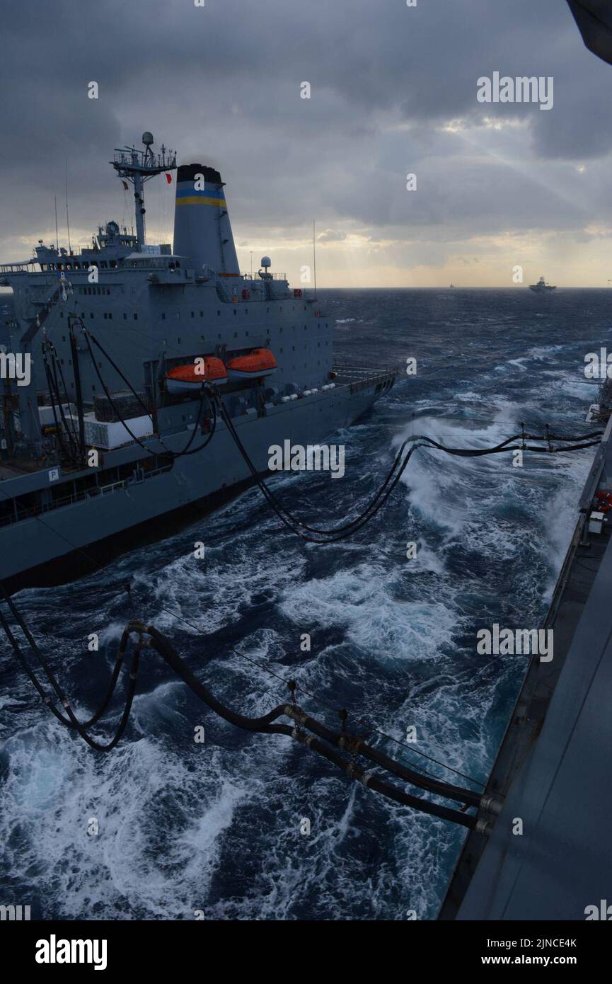 The amphibious transport dock ship USS Mesa Verde (LPD 19), right ...