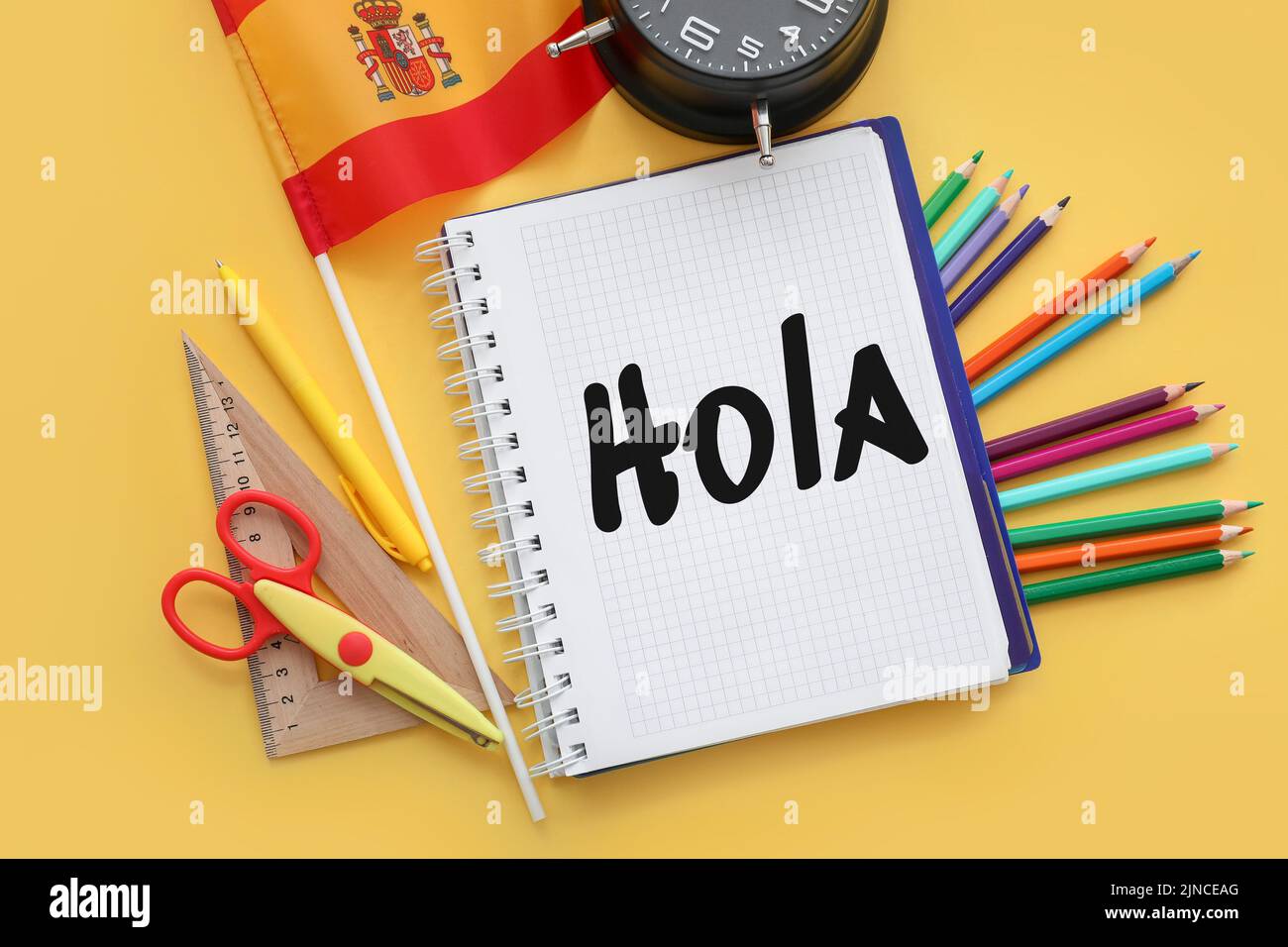 Notebook with text HOLA (Spanish for HELLO), flag of Spain and ...