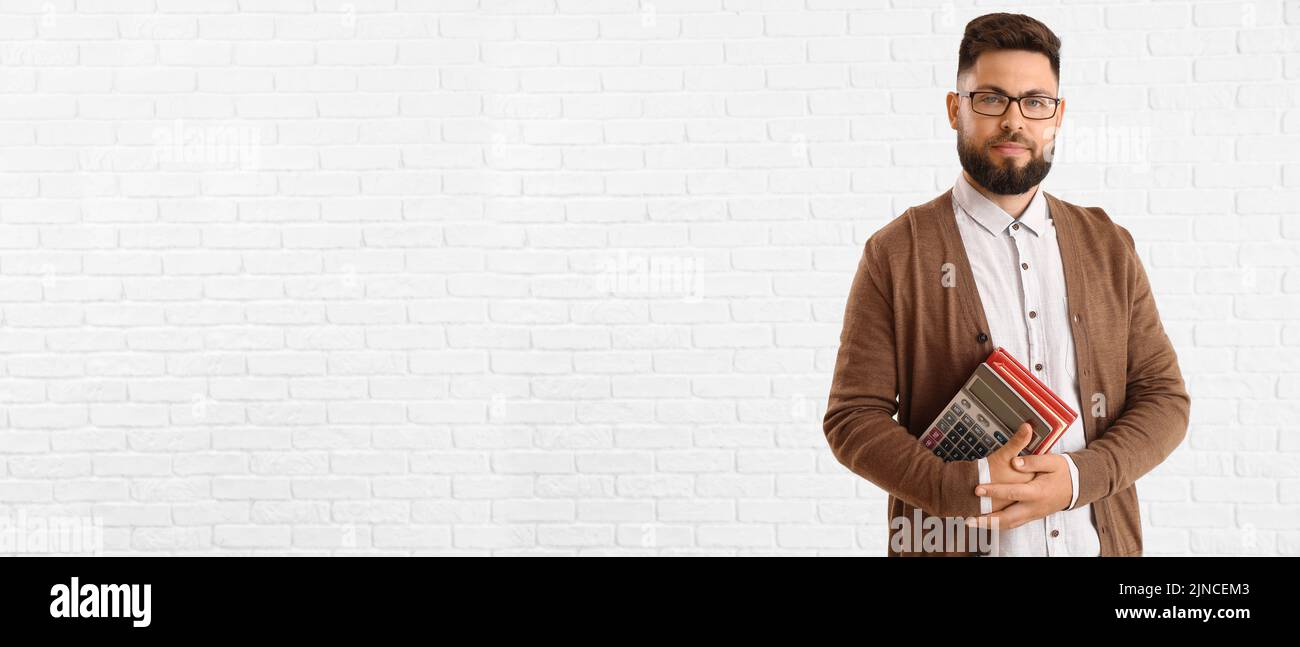 Male math teacher on white brick background with space for text Stock ...