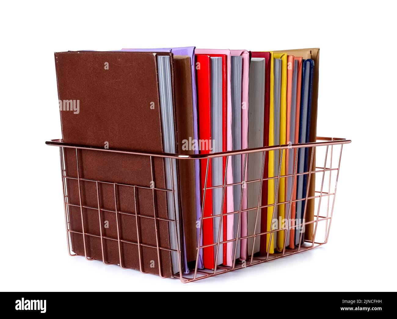 Pink metal basket with books on white background Stock Photo - Alamy