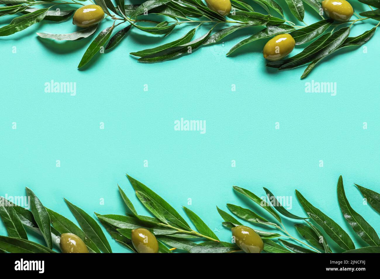Frame made of green olives and leaves on blue background Stock Photo ...