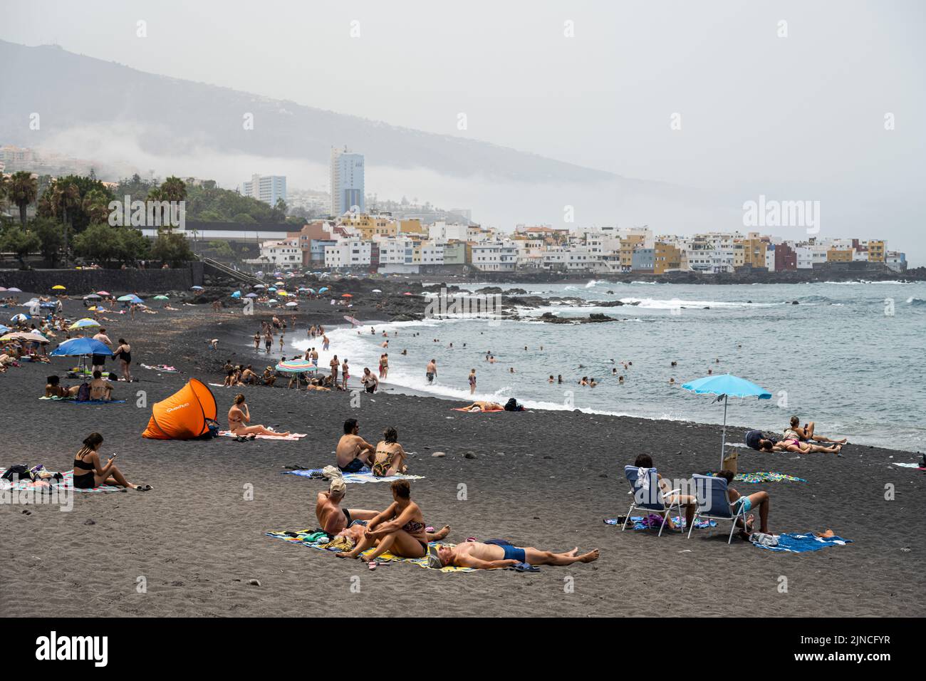 People seen relaxing at Playa del Castillo beach in Puerto de la Cruz ...