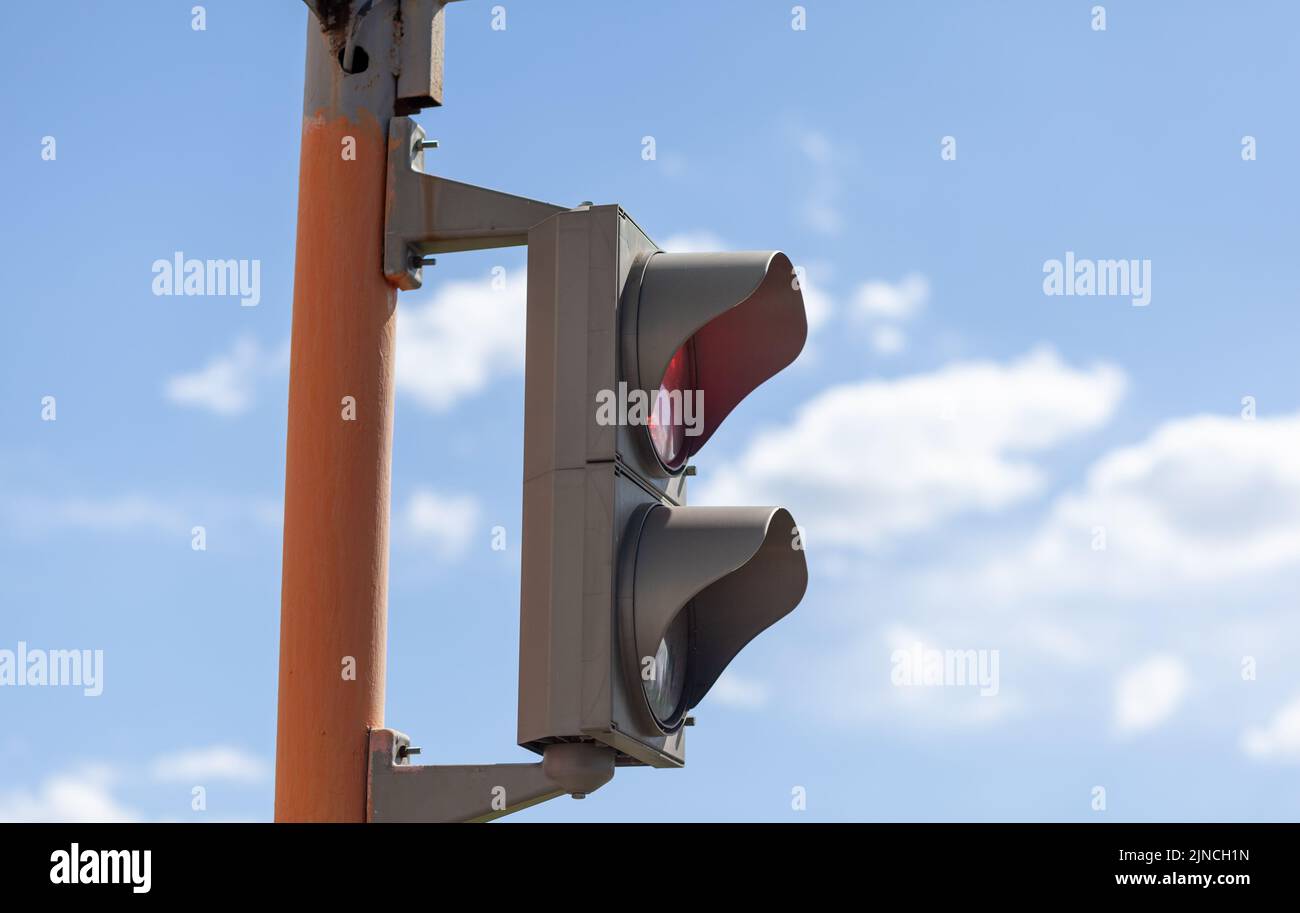 Red light on a pedestrian traffic light against a blue sky. Safe ...
