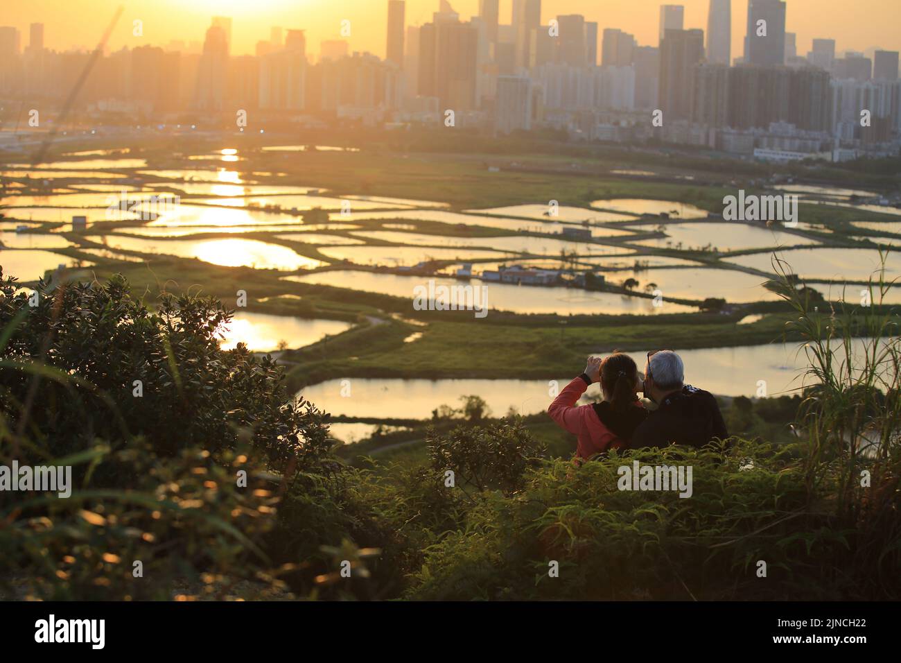 old man love and watch the sunset in front of city skyline Stock Photo ...