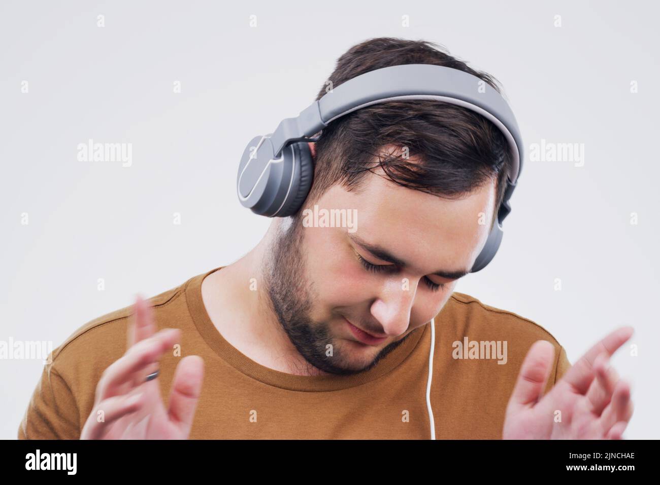 Getting groovy. Studio shot of a handsome young man dancing against a ...