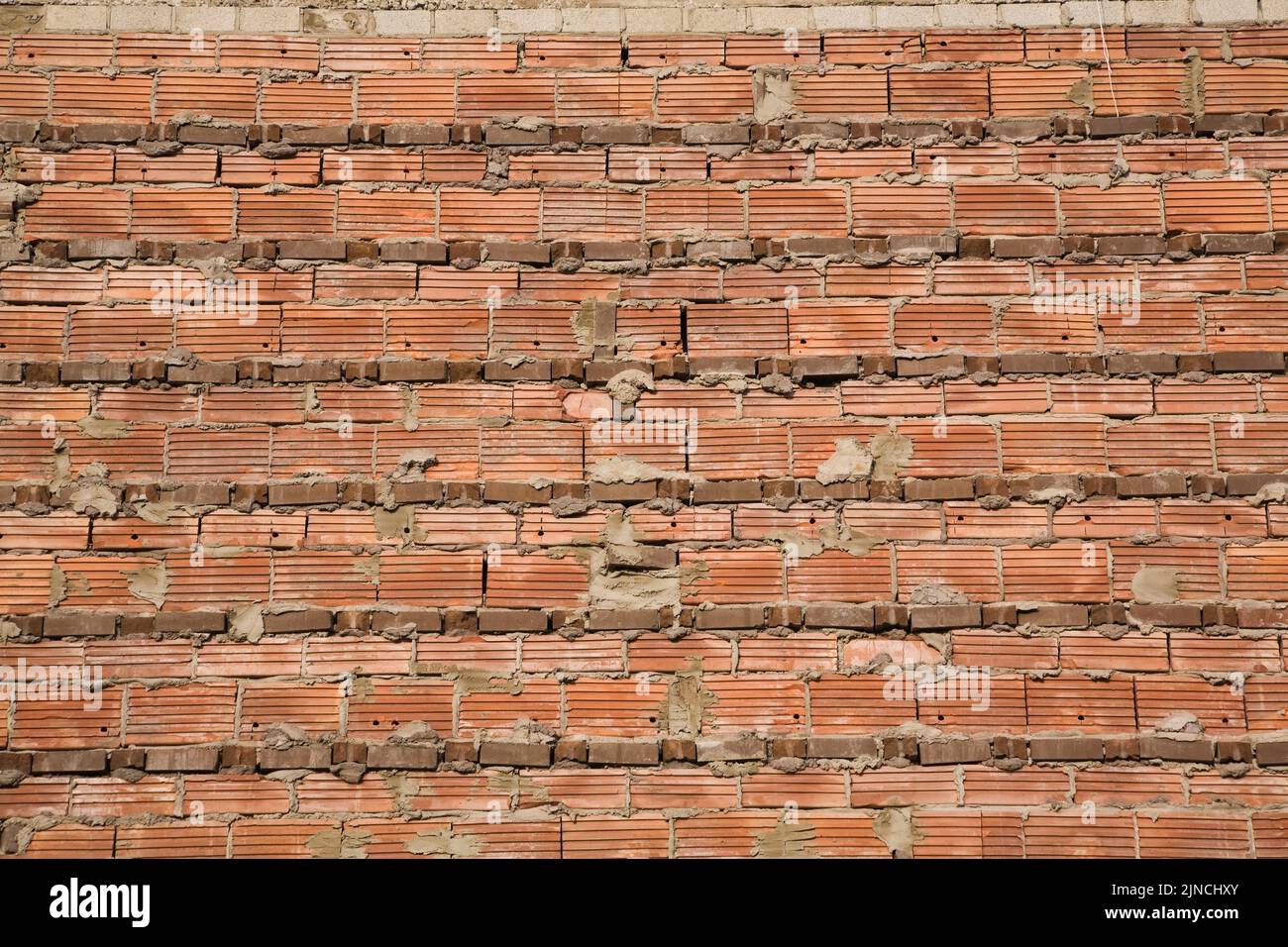 Close-up of red brick wall with exposed cement mortar joints Stock ...