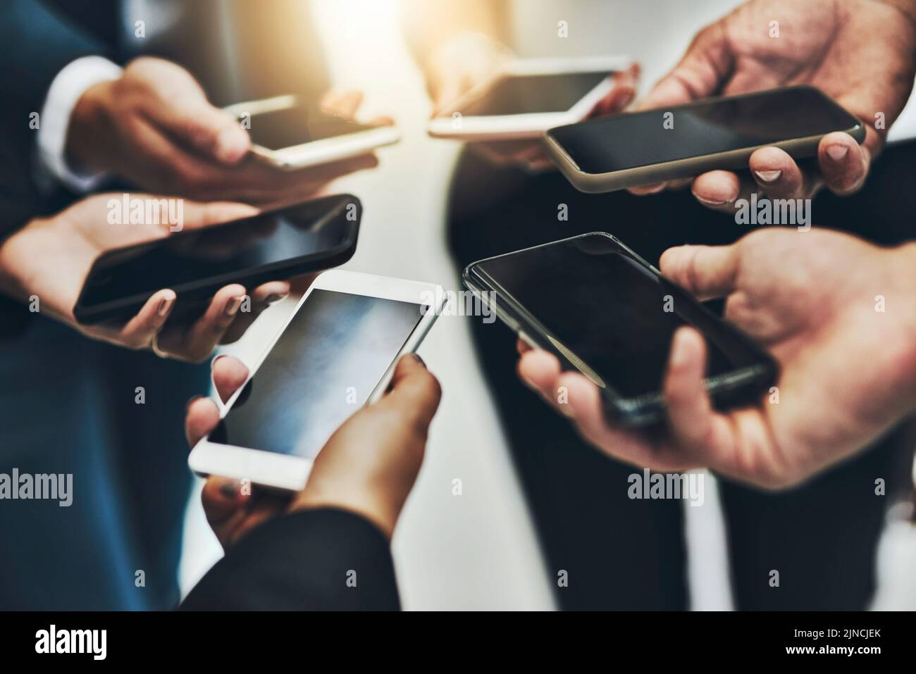 Lets have a chat. a group of unrecognizable businesspeople texting on ...