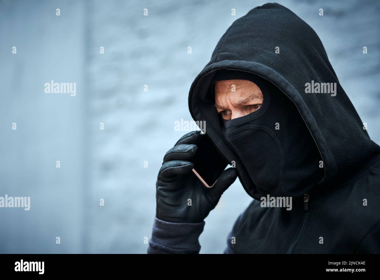 The job is done, Ill call you back later. a male burglar taking a phone ...