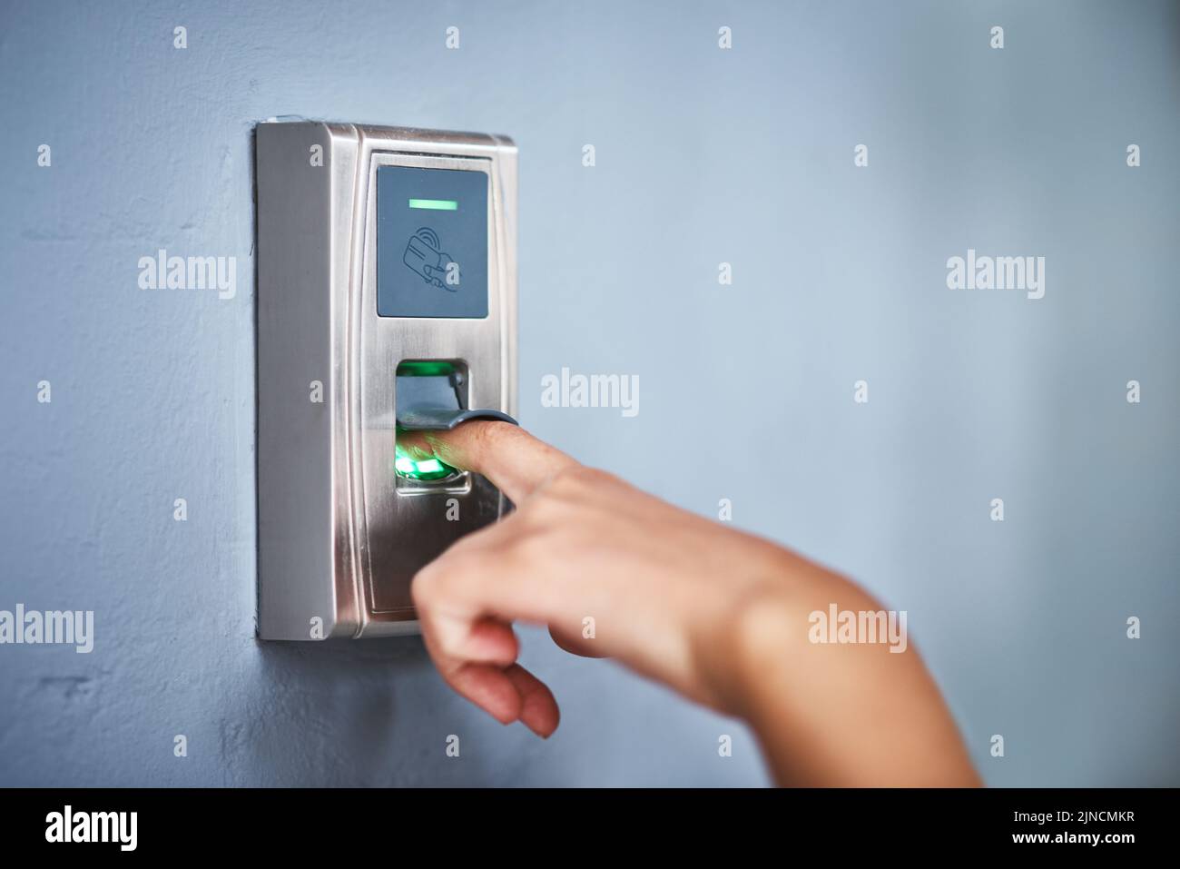 The safest form of entry. an unrecognizable woman using a fingerprint ...