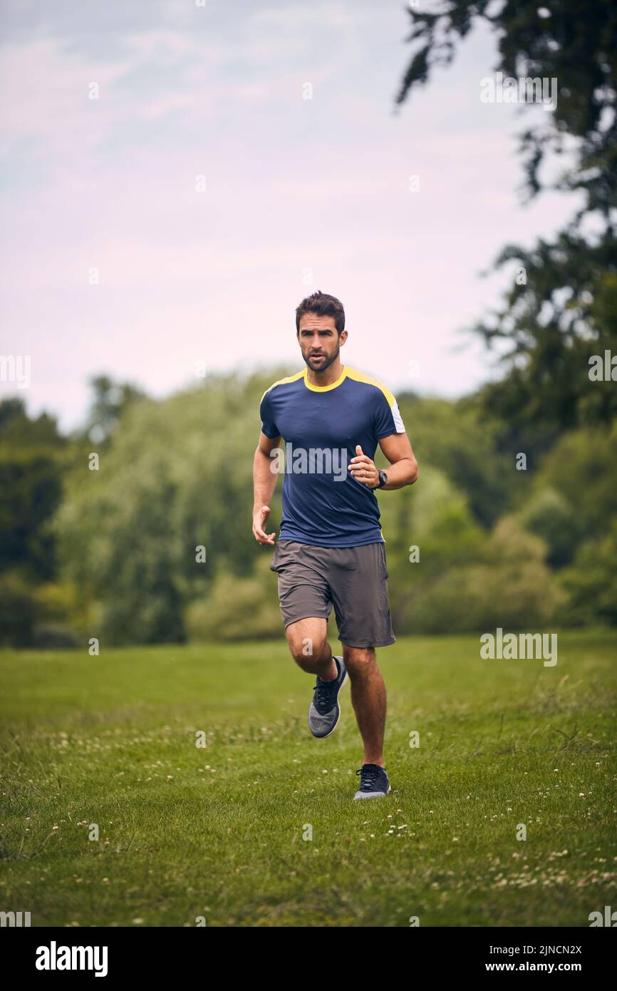Man running towards trees hi-res stock photography and images - Alamy