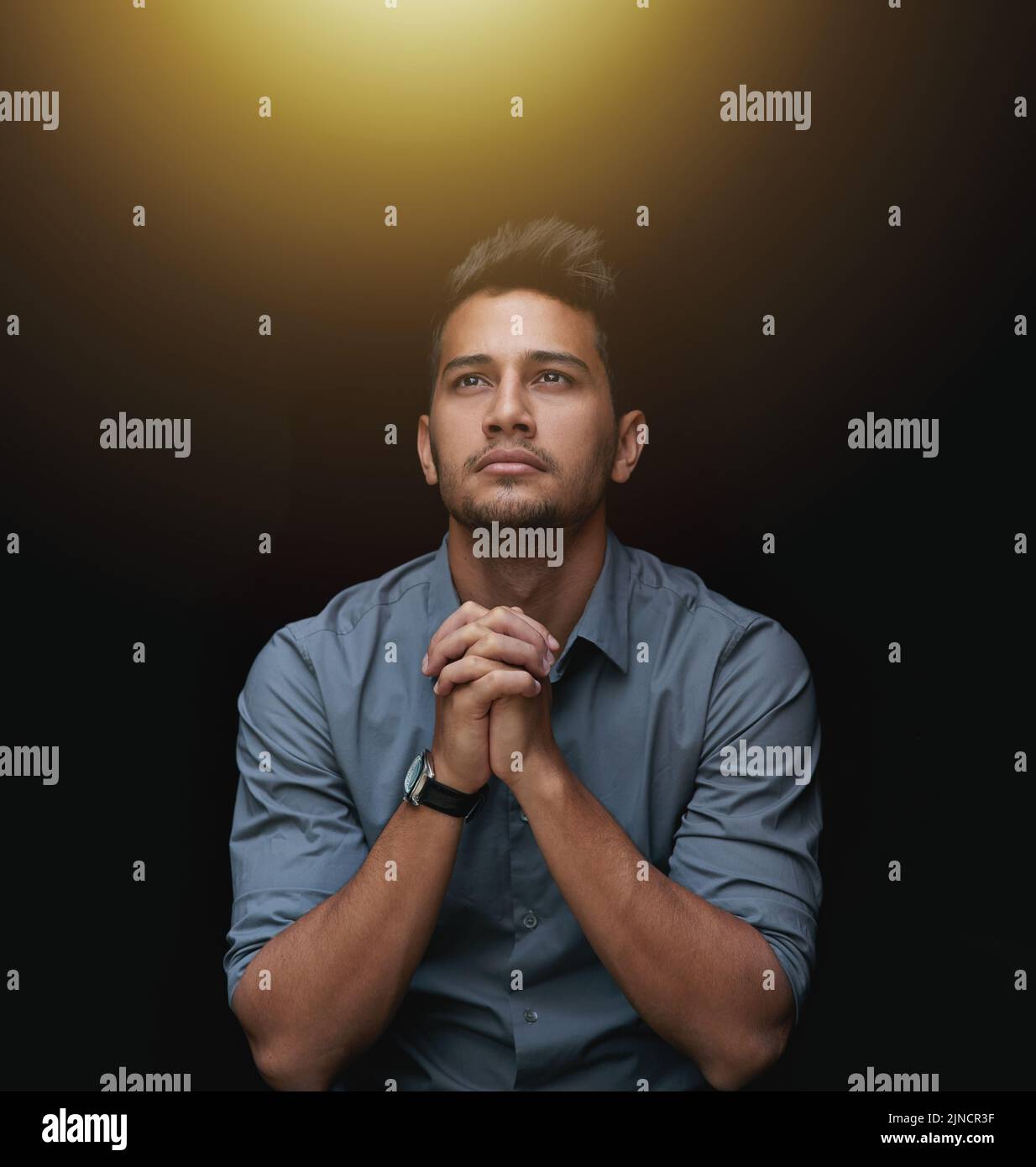 Asking for divine intervention. a handsome young businessman sitting ...