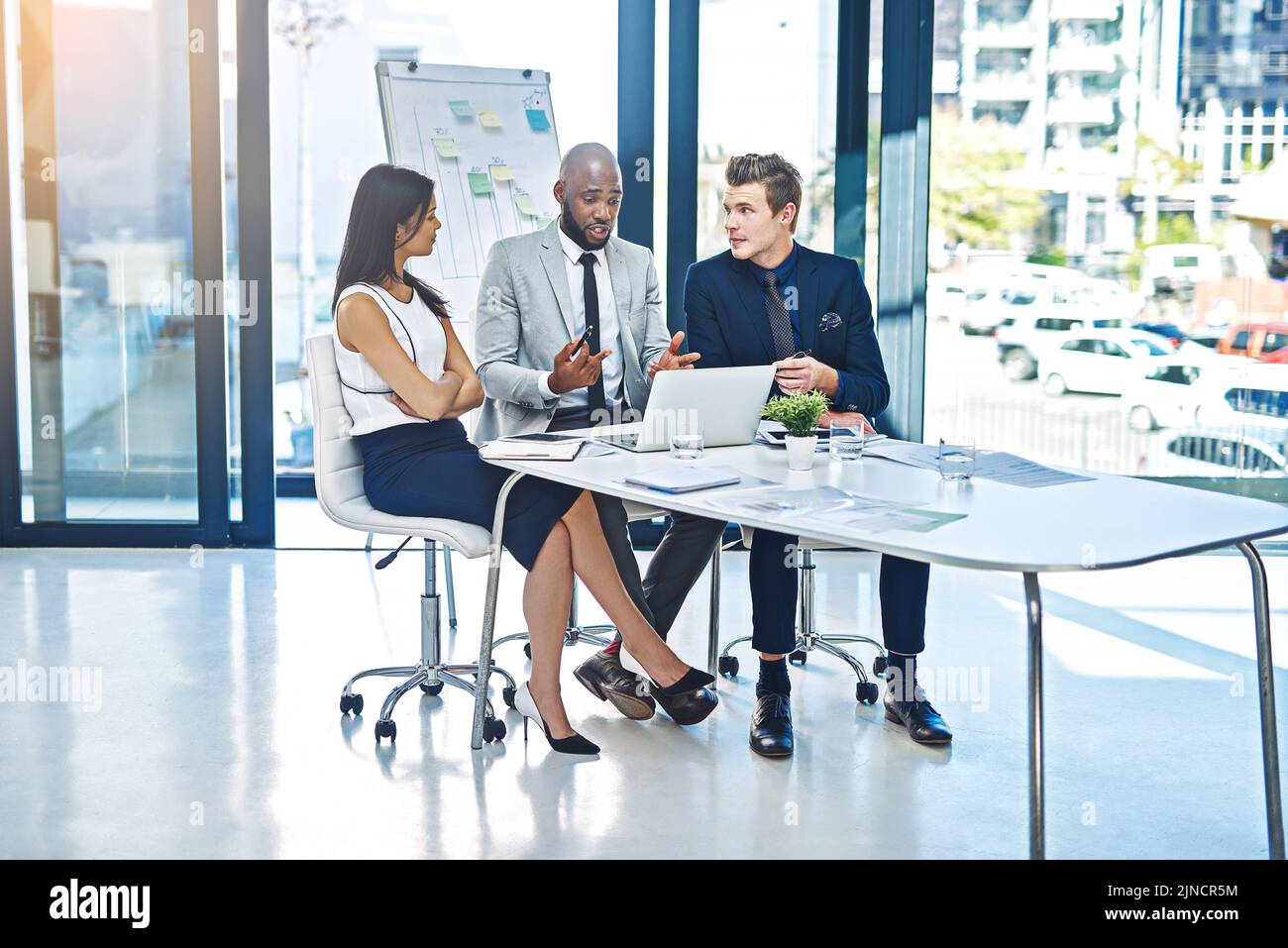 Putting his input onto the table... Full length shot of a group of ...