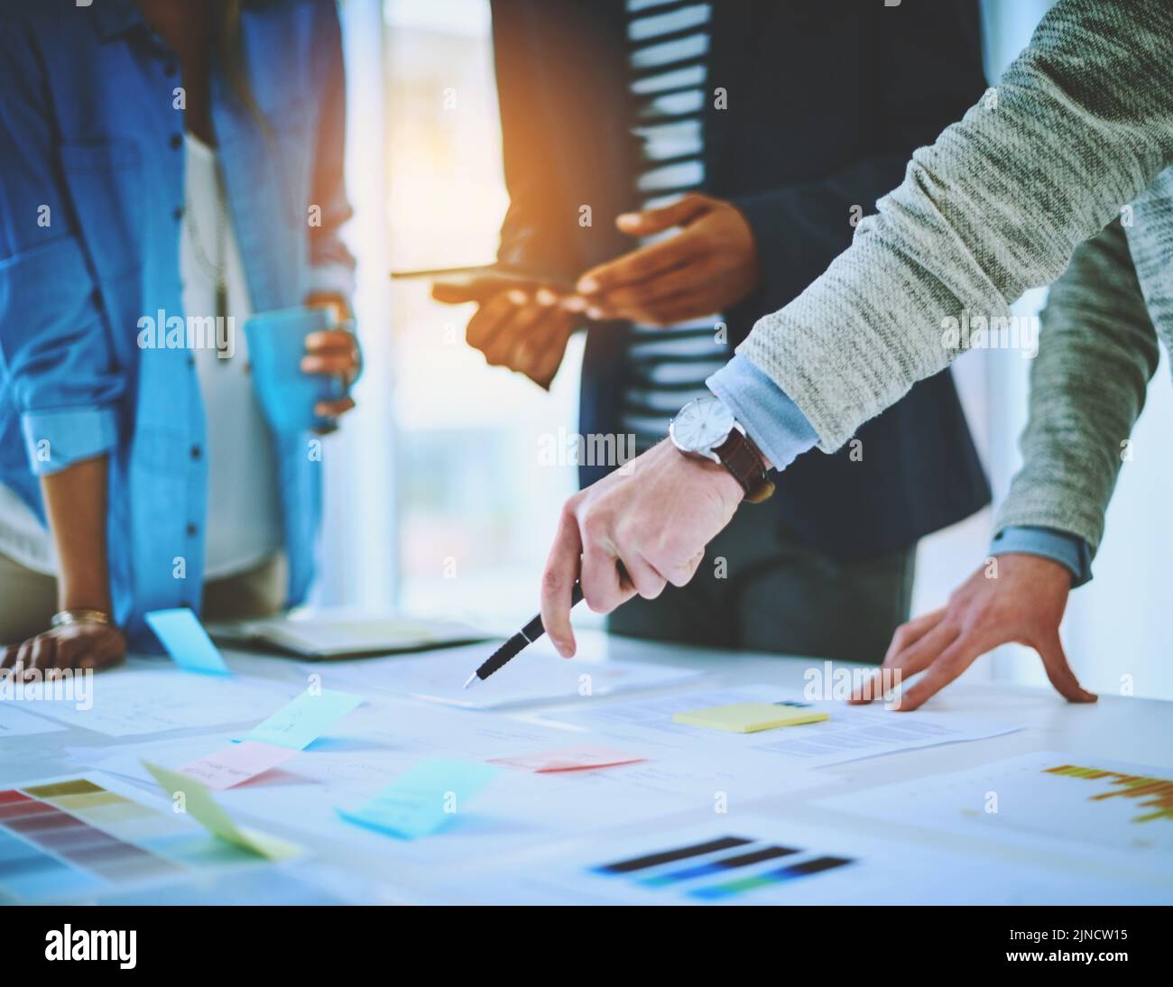 Hes stating out important facts in the meeting. a group of ...