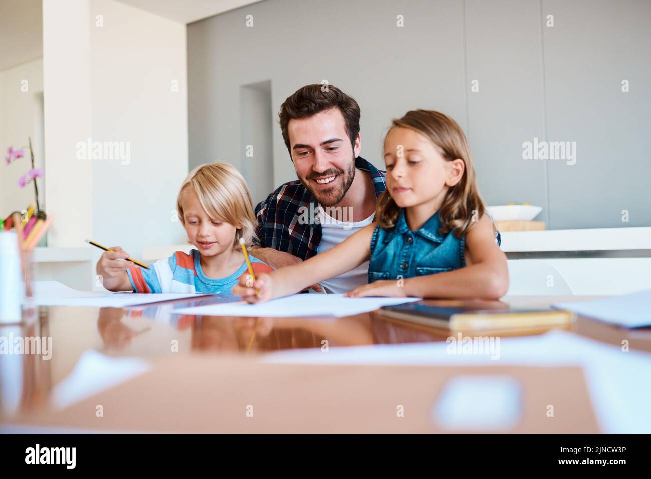 Your presence plays a big role in their lives. a young father helping ...