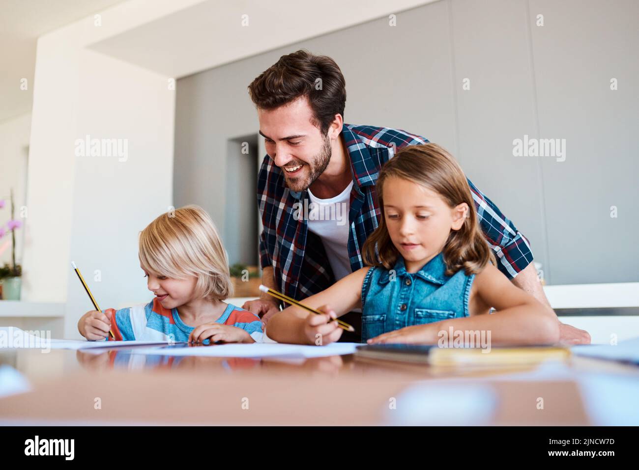 Picture perfect. a young father helping his two small children with ...