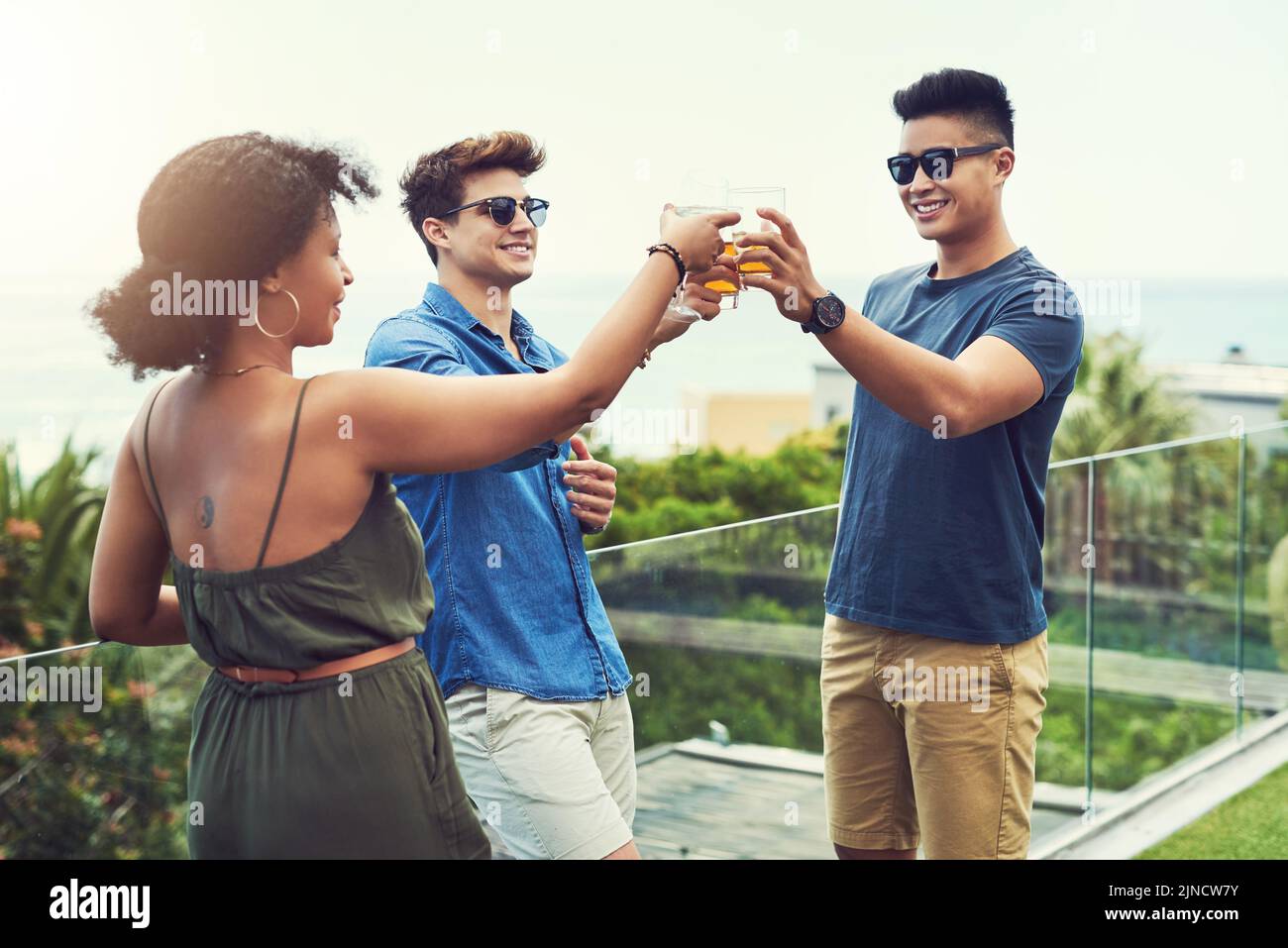 Toasting to many more years of friendship. a group of friends having ...