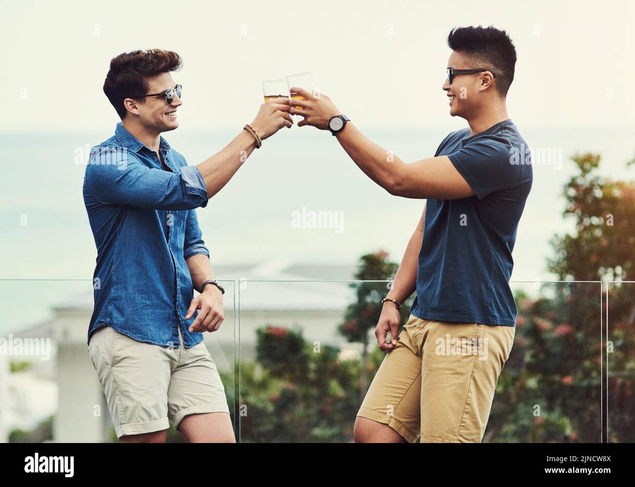 Heres to a lifetime of friendship buddy. two handsome young men having ...