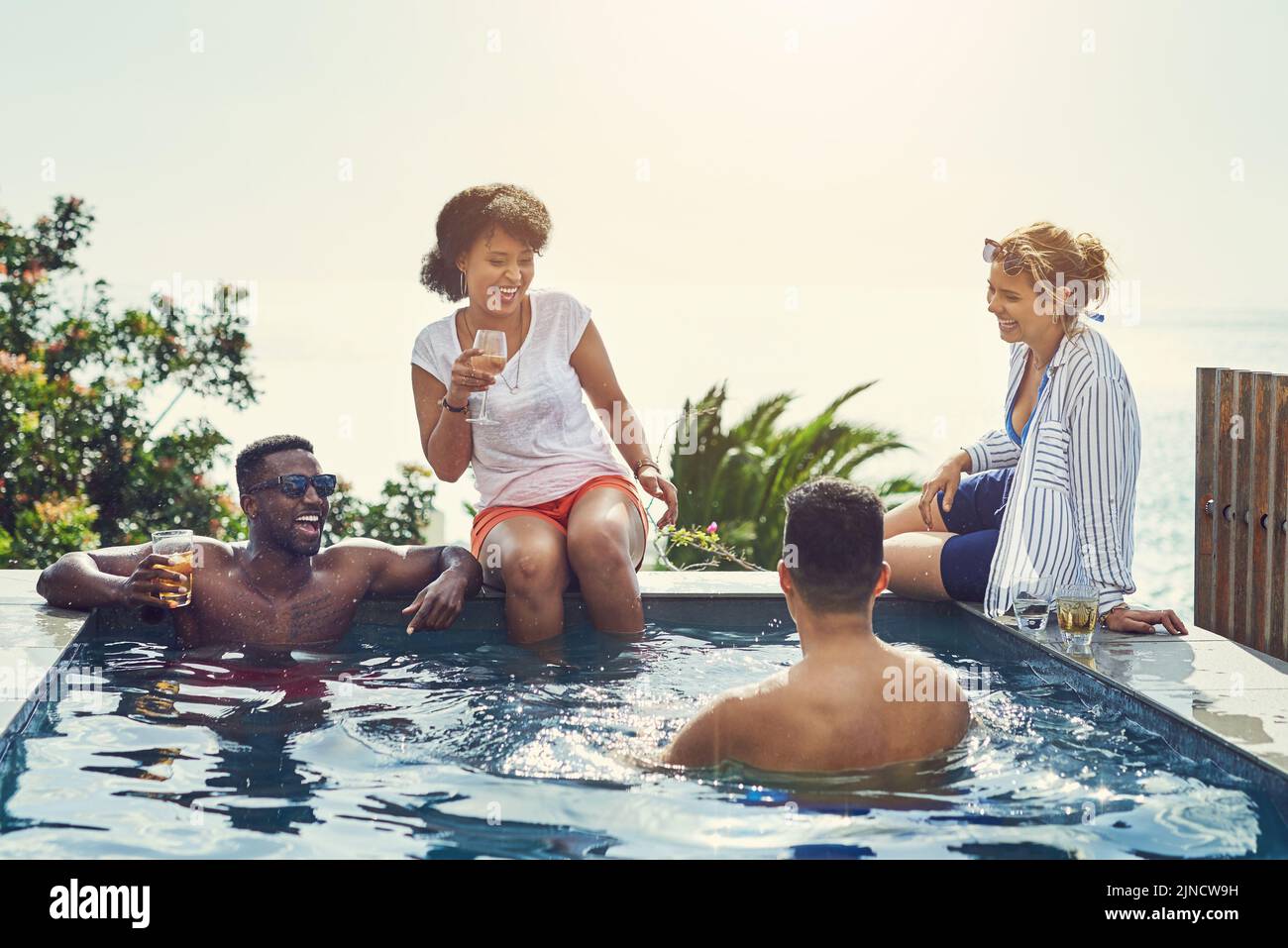 Ending their year off with a splash. a group of friends having drinks ...