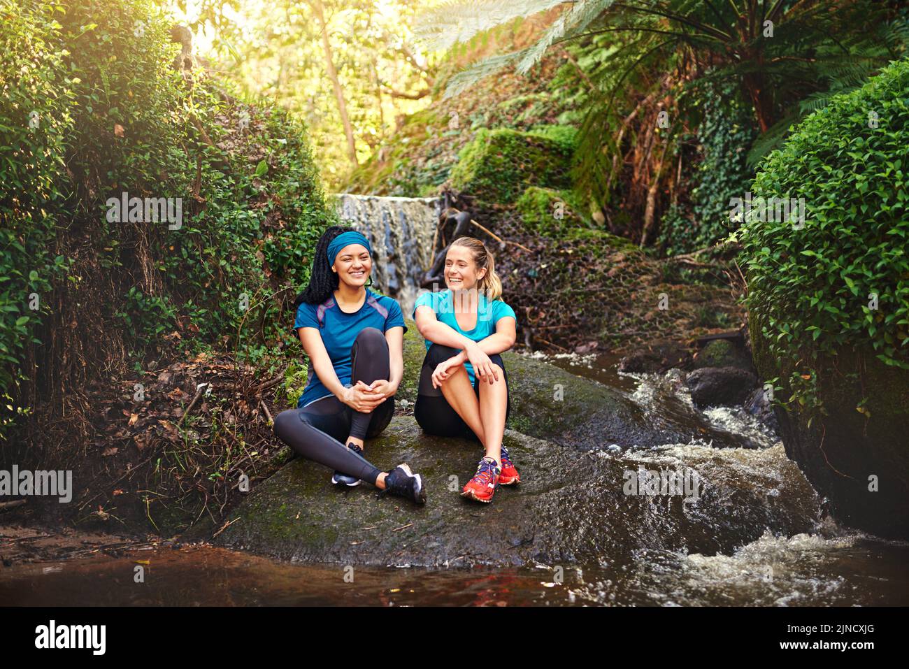 They appreciate nature. two sporty young women taking a break while out ...
