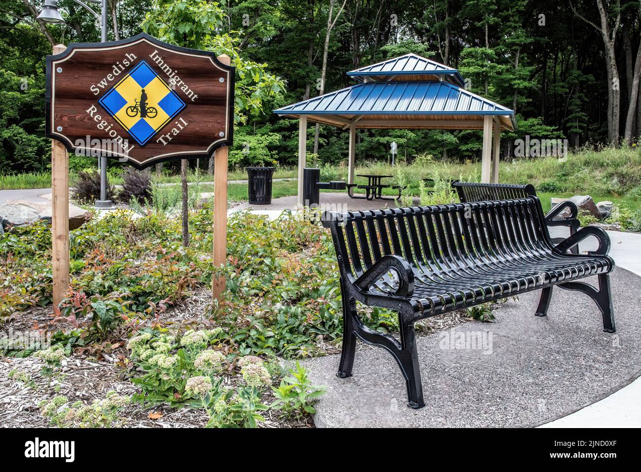 Park bench and picnic shelter with signage for the Swedish Immigrant ...