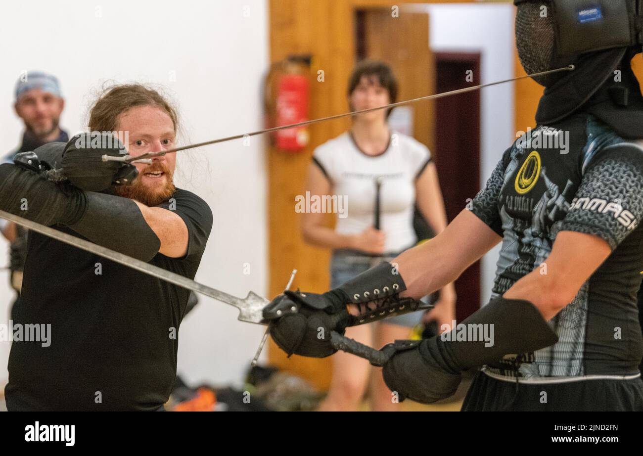 Ulm, Germany. 02nd Aug, 2022. Trainer Michael Hein (l) demonstrates ...
