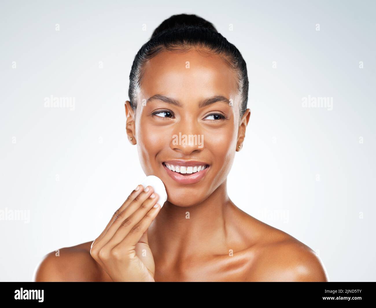 Getting that makeup off. Studio shot of an attractive young woman ...