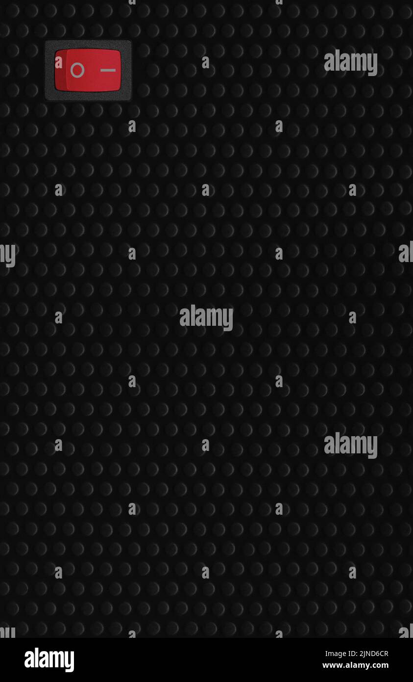 Red rectangle rocker power switch in on position, black abstract dot ...