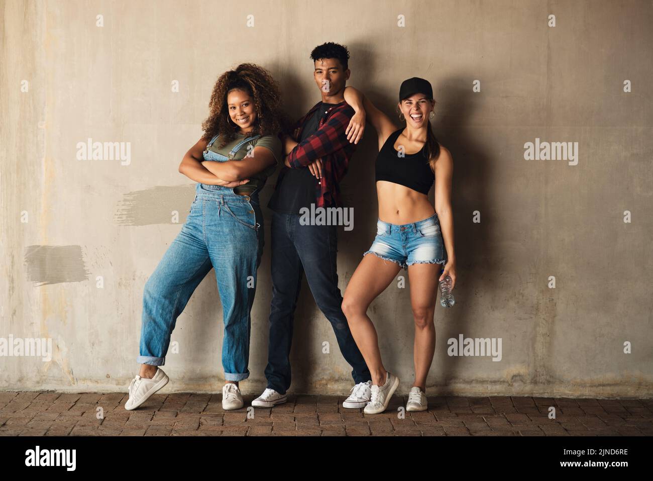 Were a mean team. Portrait of a group of cheerful young friends posing ...