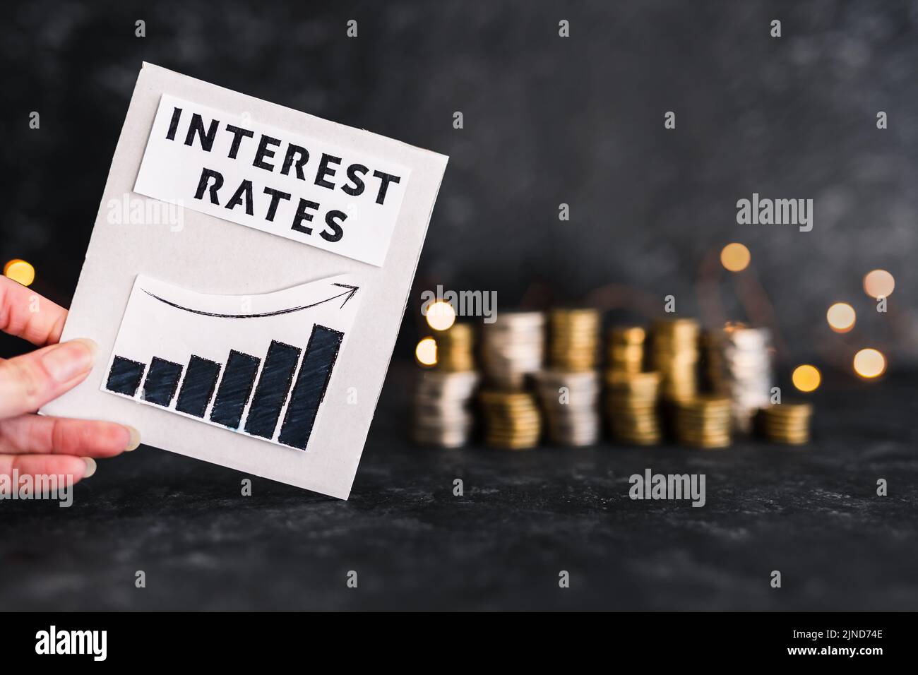 interest rates text and graph showing stats going up in front of stacks ...