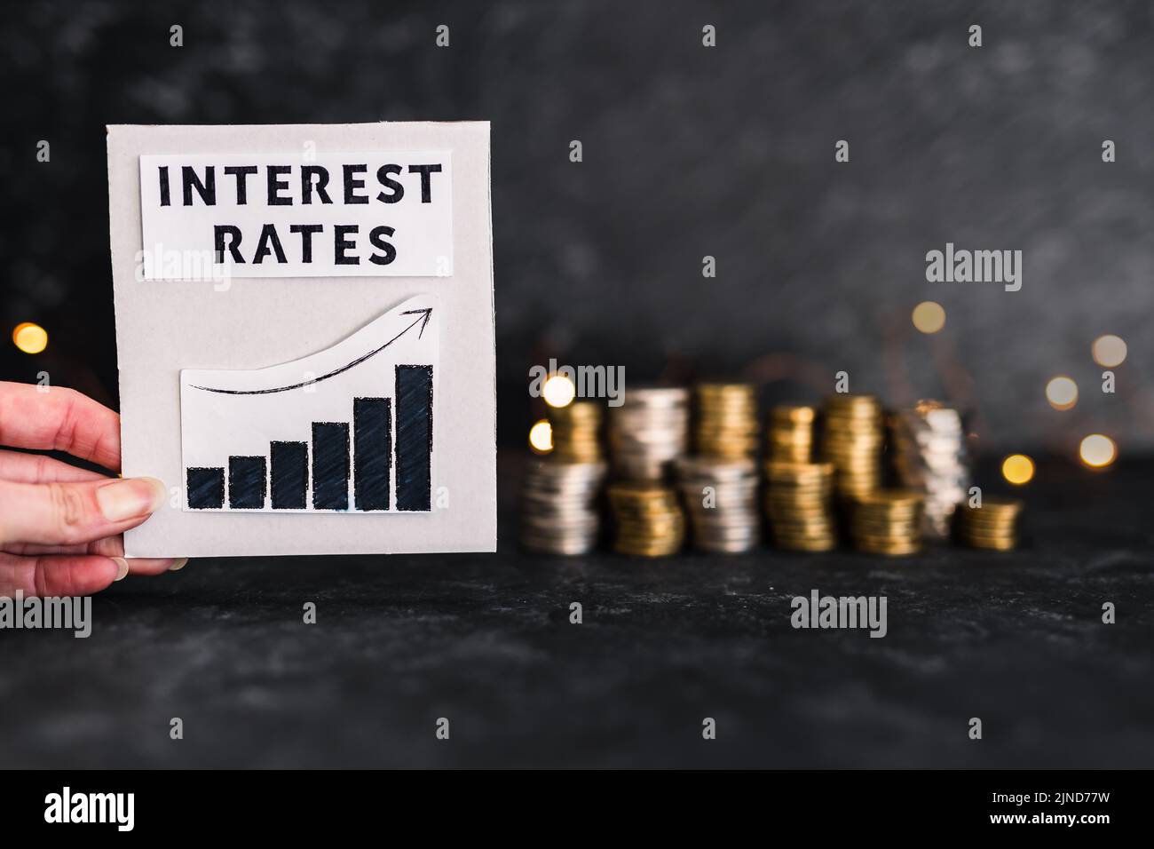 interest rates text and graph showing stats going up in front of stacks ...