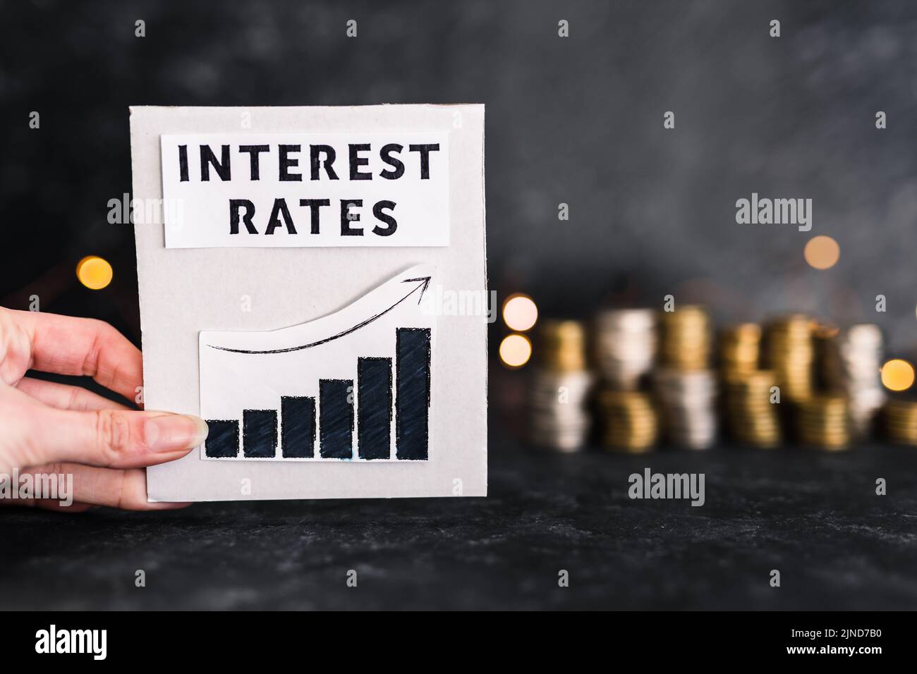 interest rates text and graph showing stats going up in front of stacks ...