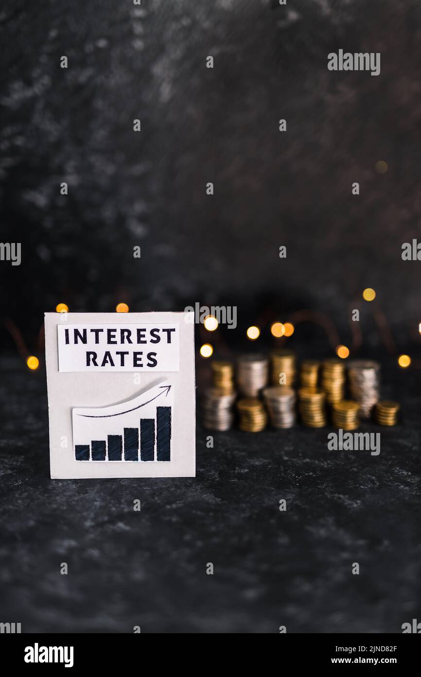 interest rates text and graph showing stats going up in front of stacks ...