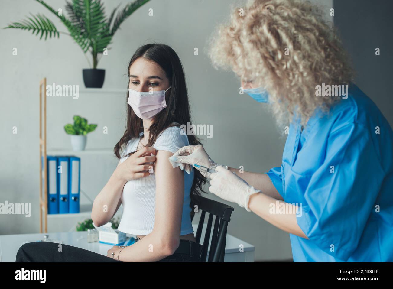 Nurse giving to a patient an injection at a hospital. Virus, epidemic ...