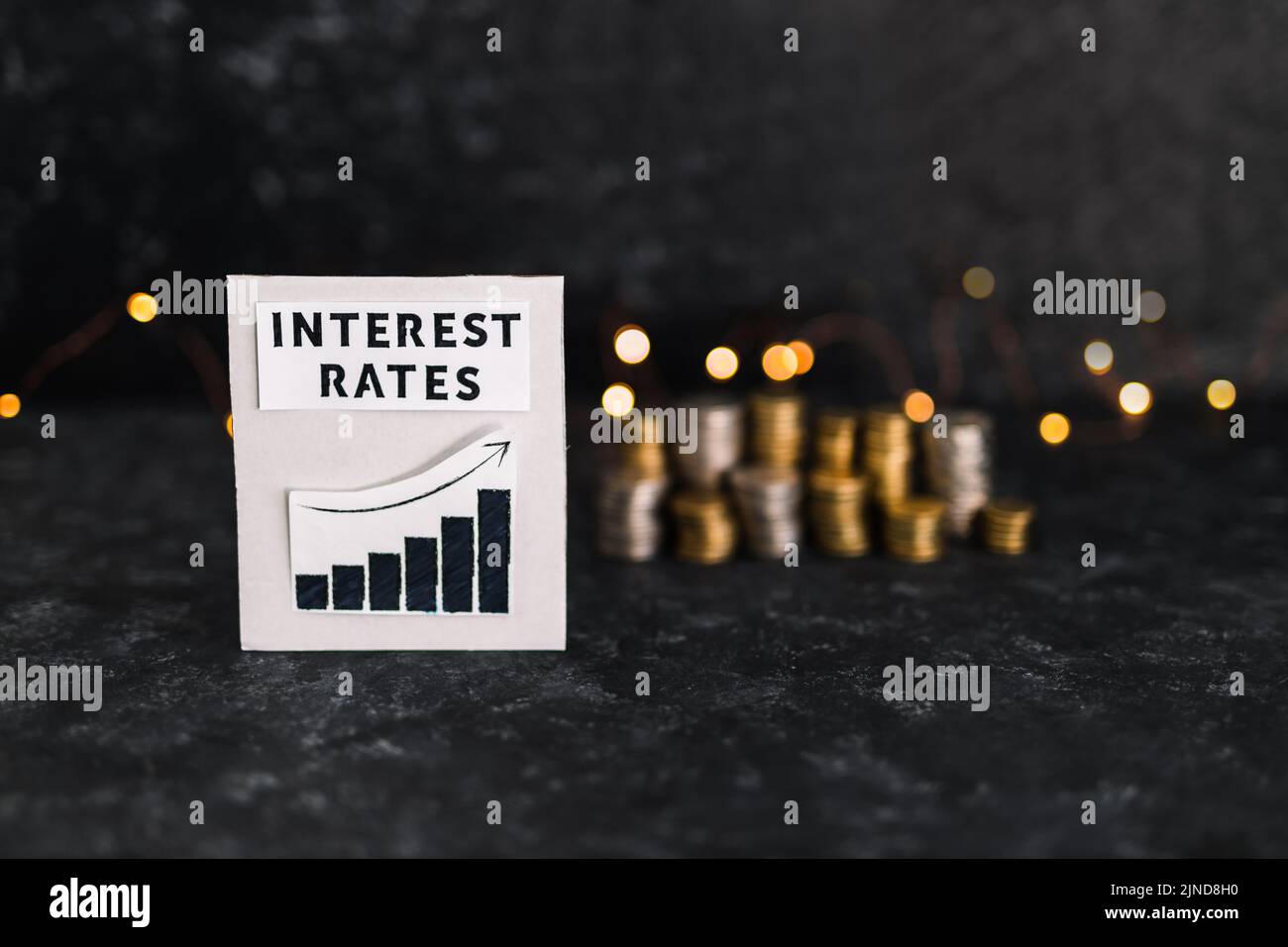 interest rates text and graph showing stats going up in front of stacks ...