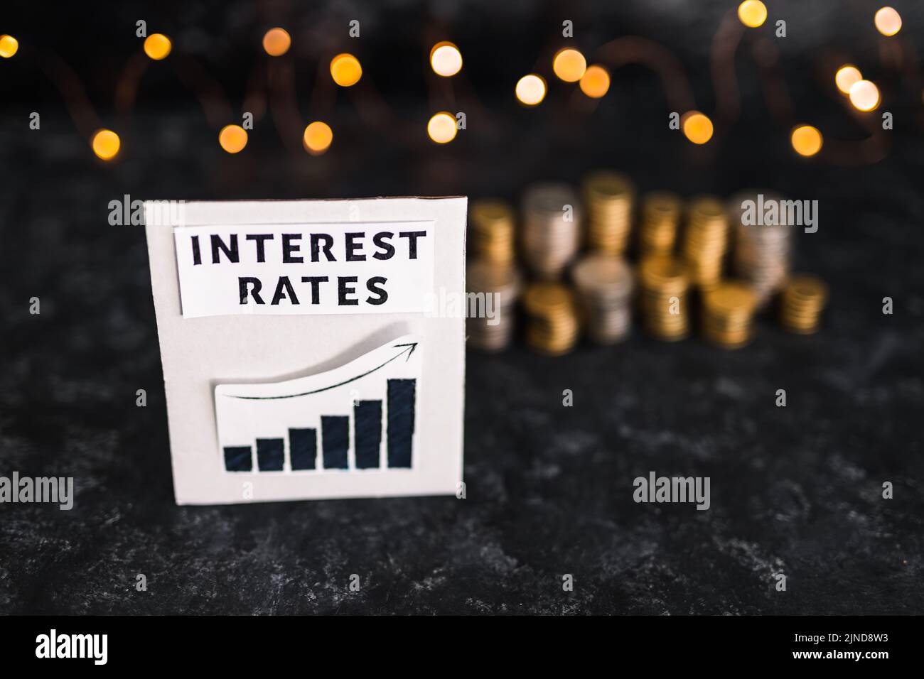 interest rates text and graph showing stats going up in front of stacks ...