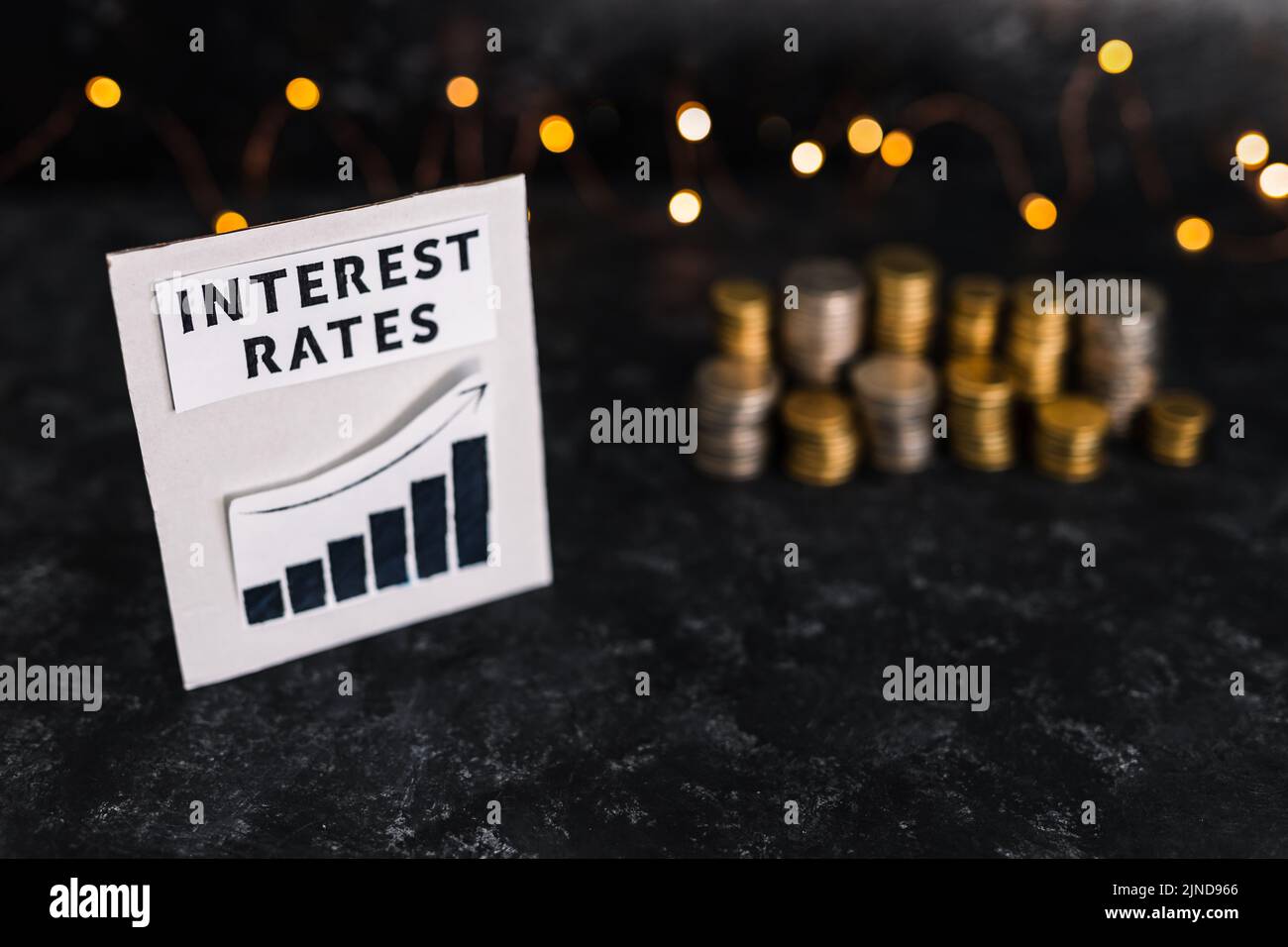 interest rates text and graph showing stats going up in front of stacks ...